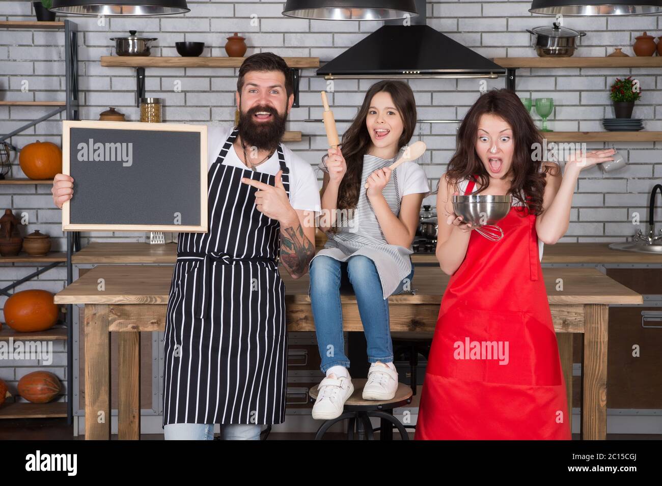Mother and father teaching daughter how to cook. small girl with mom ...