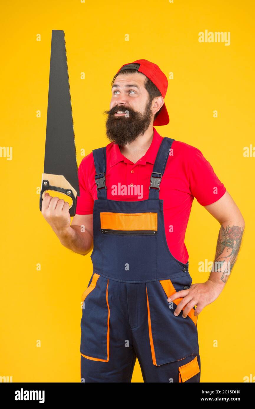 Reliable tool. Builder working with saw. Worker with hand saw. Man ...