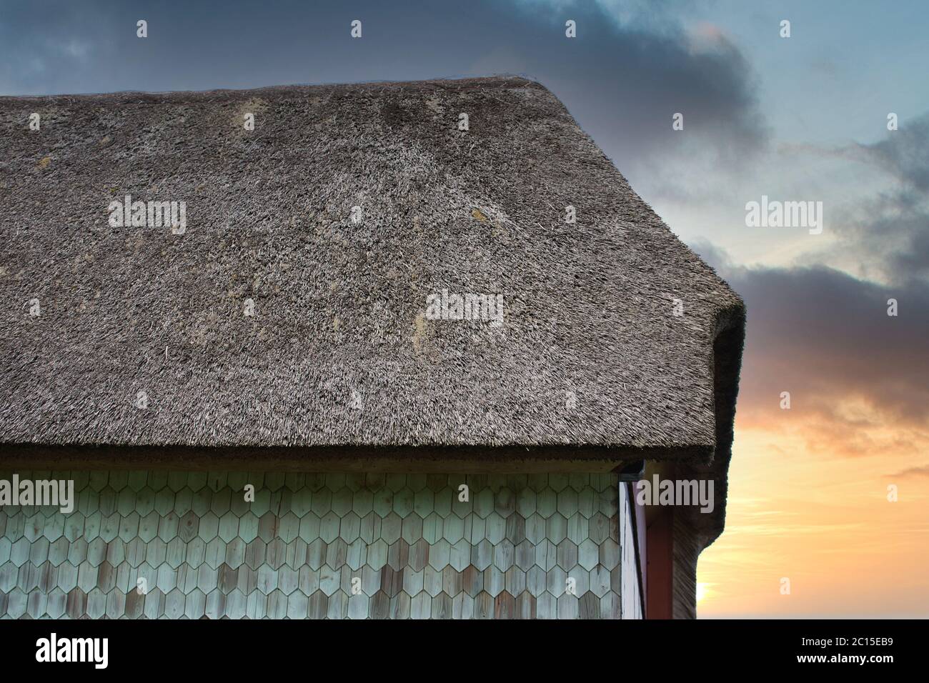 House with thatched roof at sunset Stock Photo - Alamy