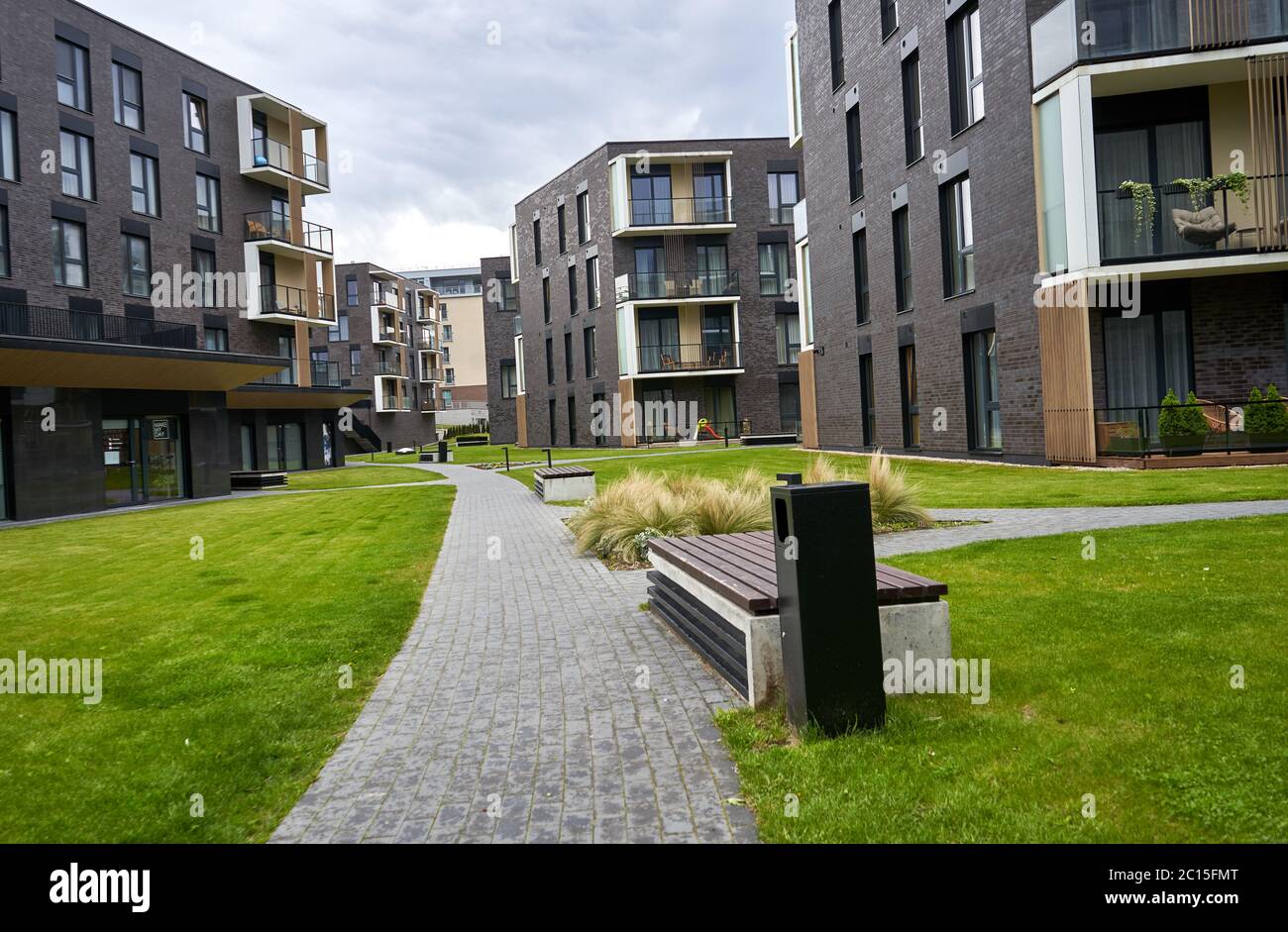 Garden with path between new apartment buildings Stock Photo - Alamy