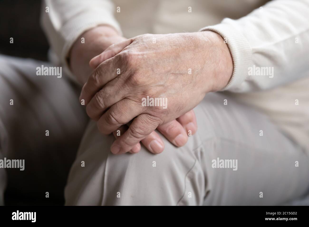 Close up elderly lonely man folded hands on lap Stock Photo - Alamy