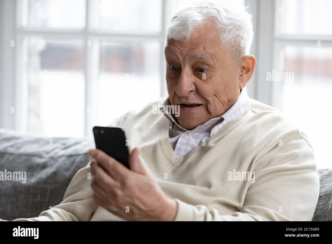 Close up surprised excited mature man looking at phone screen Stock ...