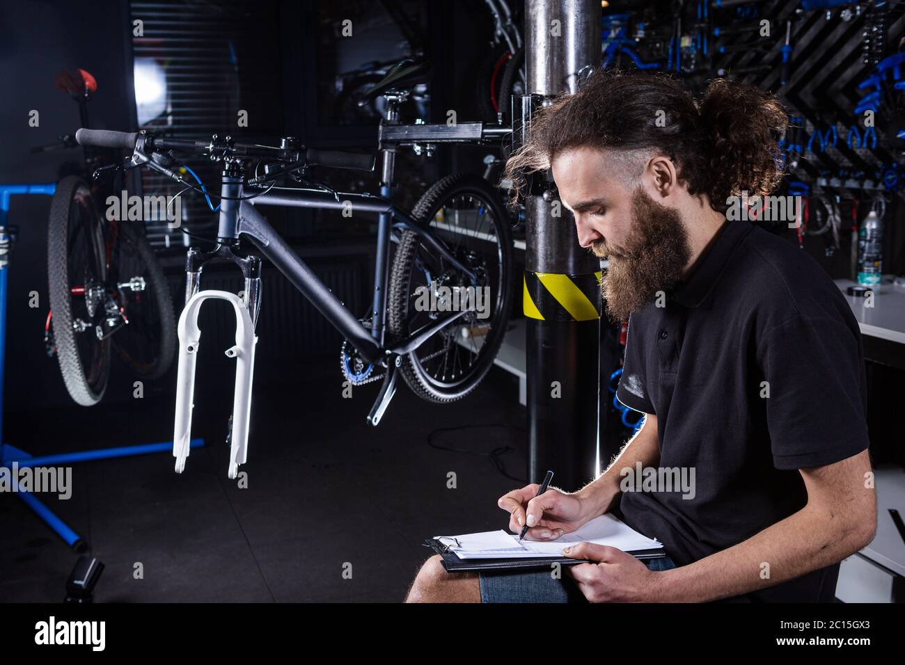 Bicycle Workshop Technician Doing Administrative Work. Bicycle mechanic ...