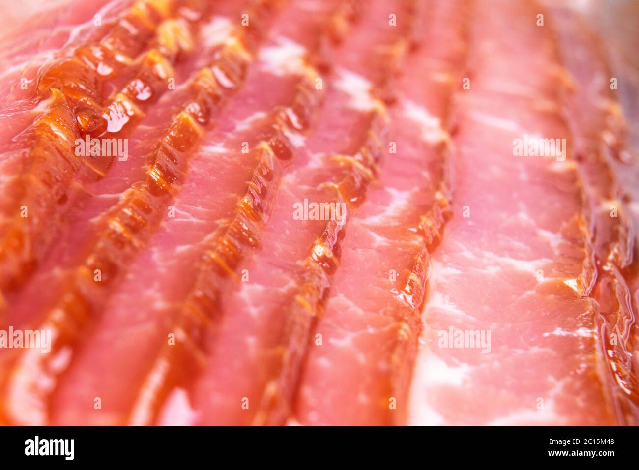 Macro shot several rows of sliced smoked bacon isolated on white ...