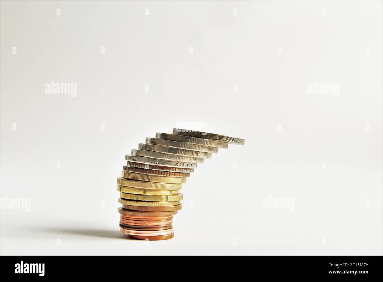 Stack money coins are about to fall down.photo isolate on white copy ...