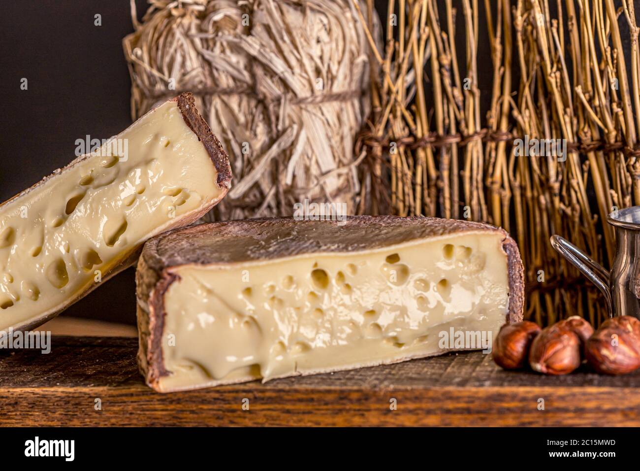 French cheese Saint Nectaire rustic collection delicious. Black ...