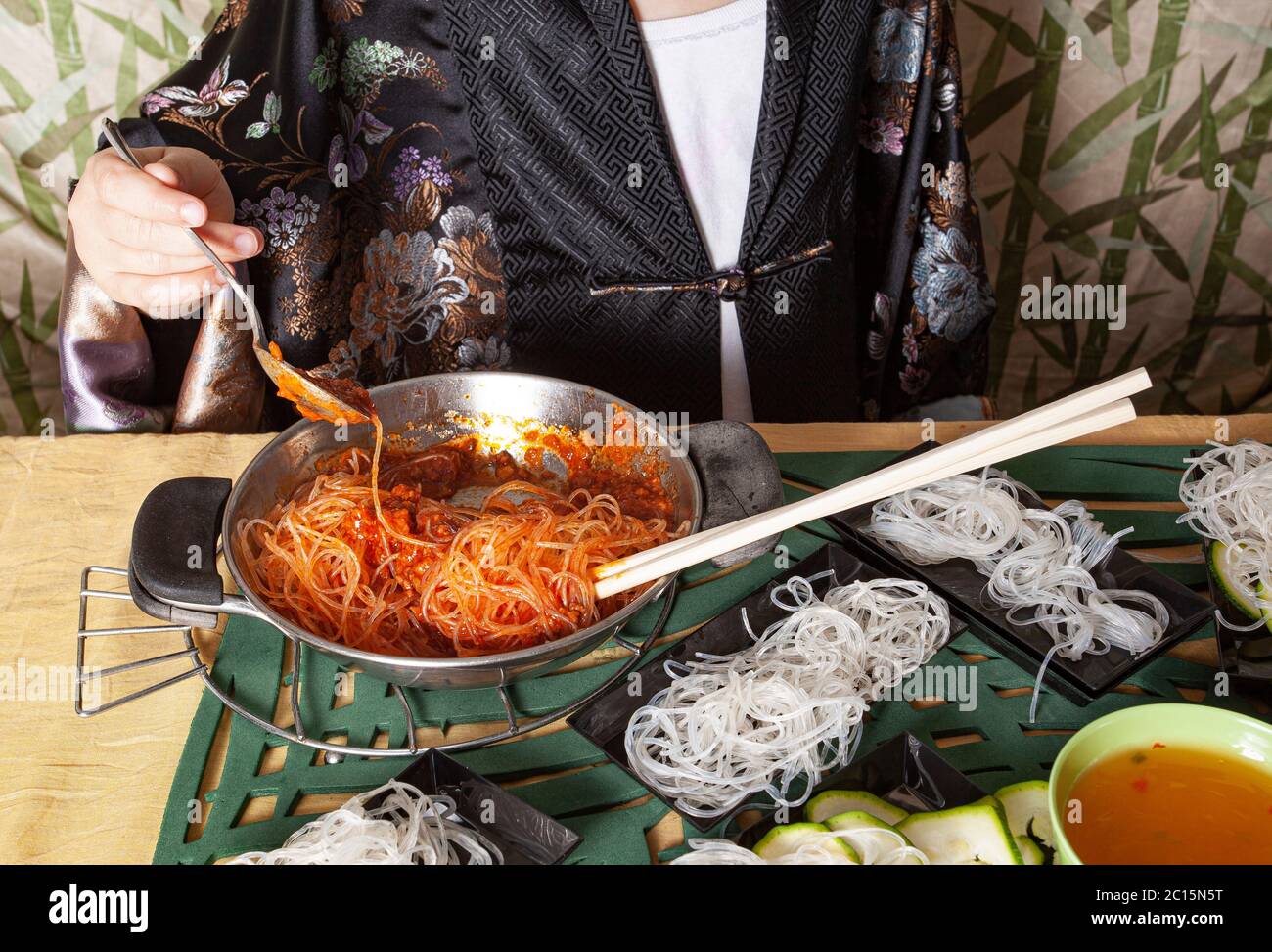 A little girl cooks Chinese noodles and Bolognese ragù, in studfio ...