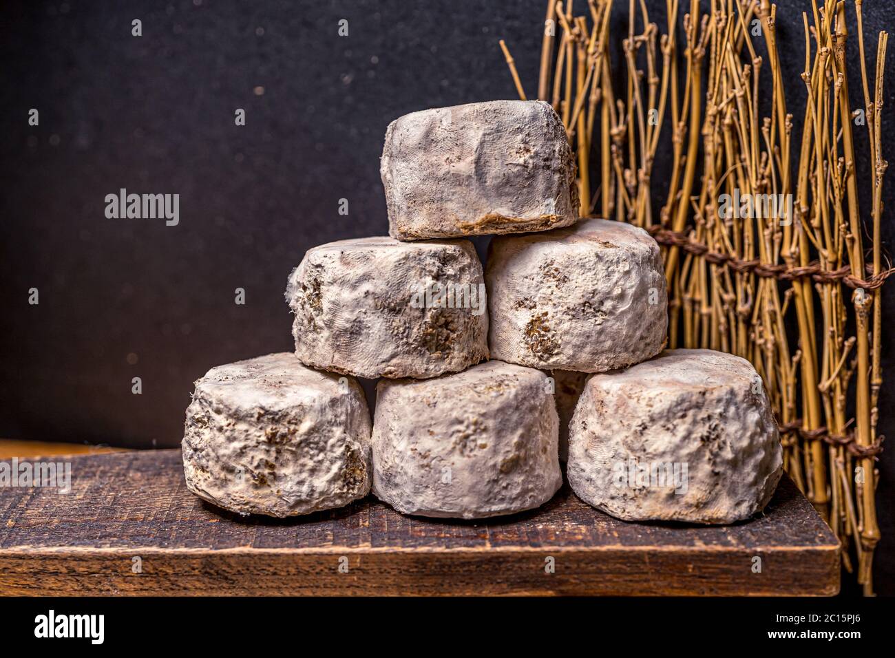 French cheese Crottin de Chavignol in the dark background. High quality ...