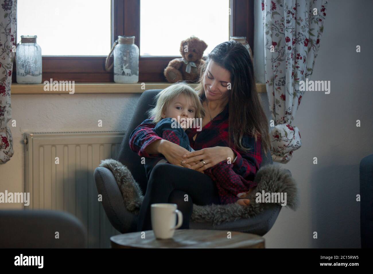 Mother and child, sitting in rocking chair, hugging Stock Photo - Alamy