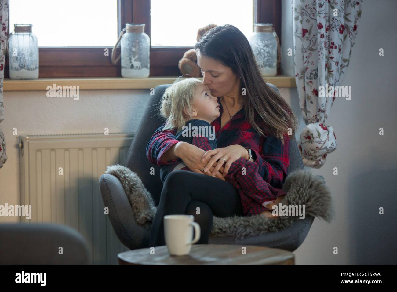 Mother and child, sitting in rocking chair, hugging Stock Photo - Alamy