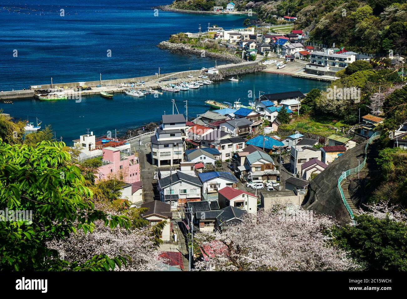A small port town in Japan in the beginning of spring., surrounded by ...