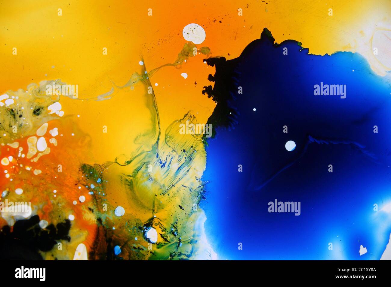 Colored liquids mixed together in fluid creating colorful abstract ...