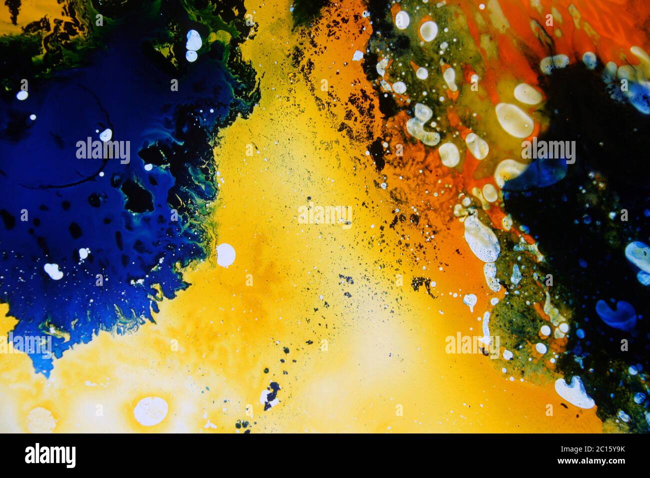 Colored liquids mixed together in fluid creating colorful abstract ...