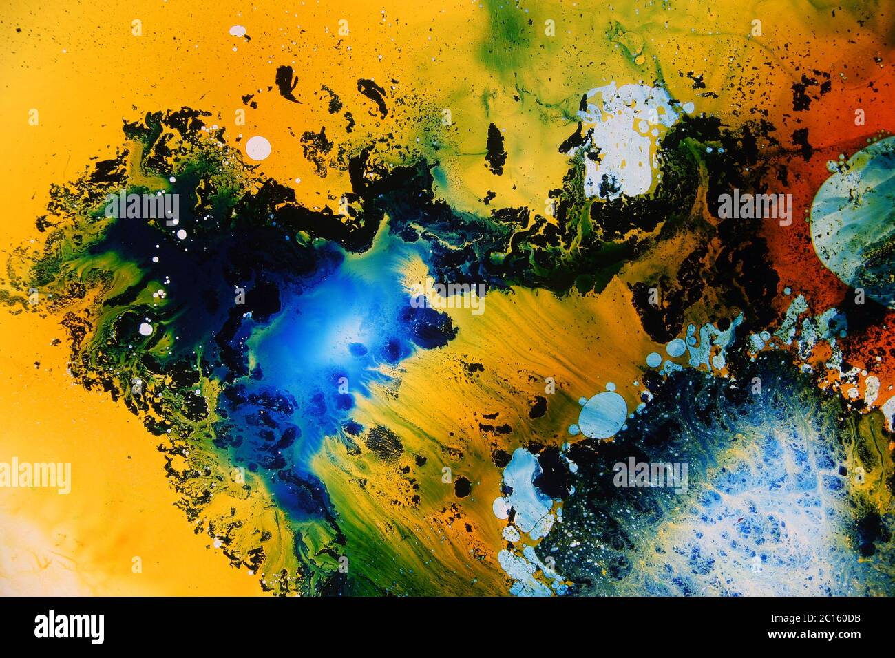 Colored liquids mixed together in fluid creating colorful abstract ...