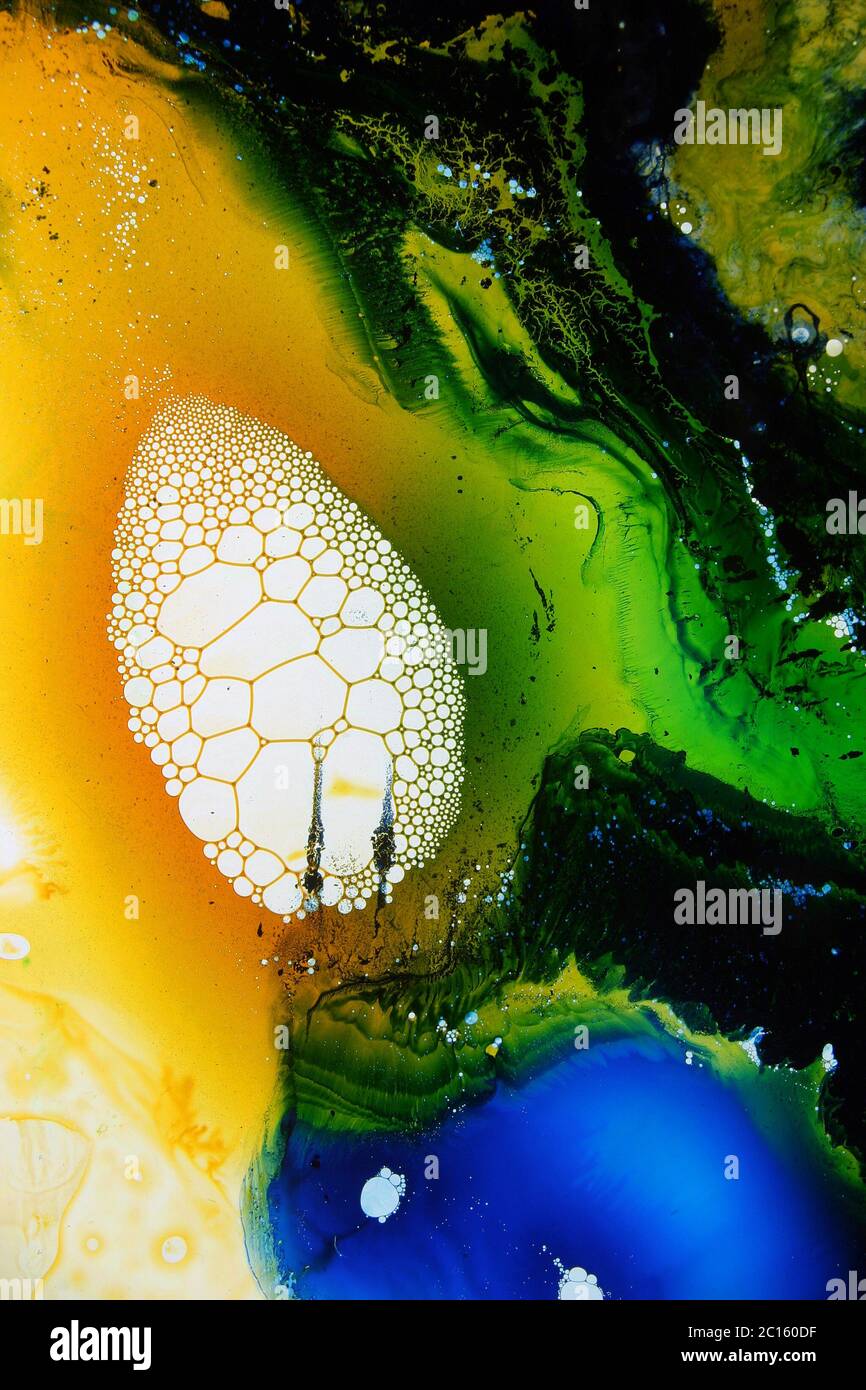 Colored liquids mixed together in fluid creating colorful abstract ...