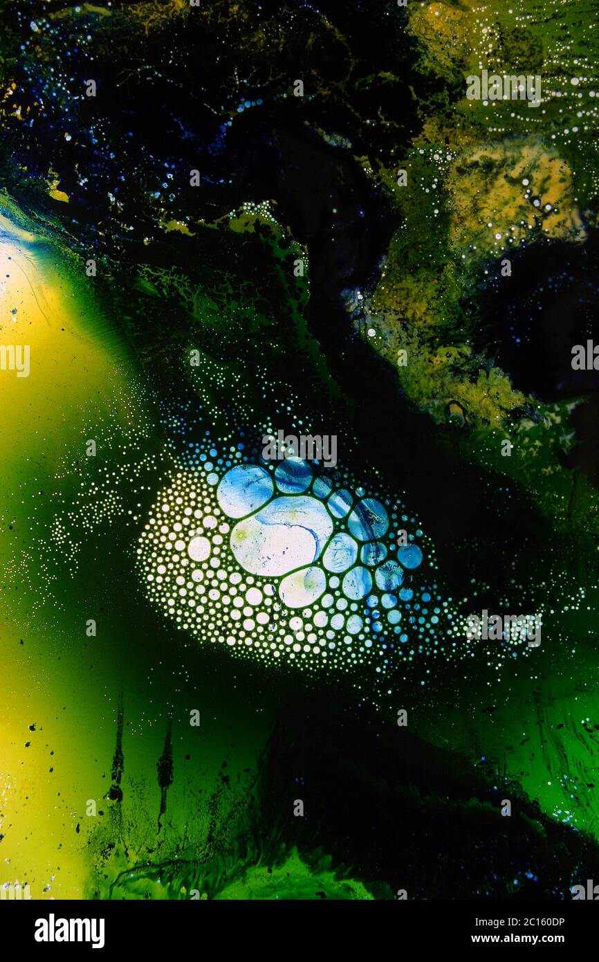 Colored liquids mixed together in fluid creating colorful abstract ...
