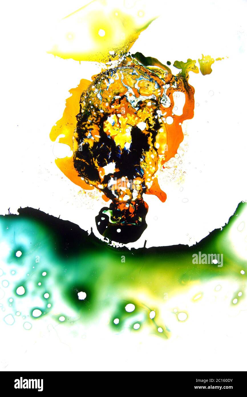 Colored liquids mixed together in fluid creating colorful abstract ...