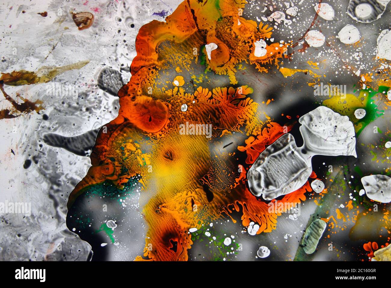 Colored liquids mixed together in fluid creating colorful abstract ...