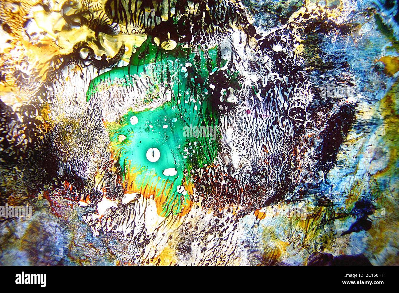 Colored liquids mixed together in fluid creating colorful abstract ...