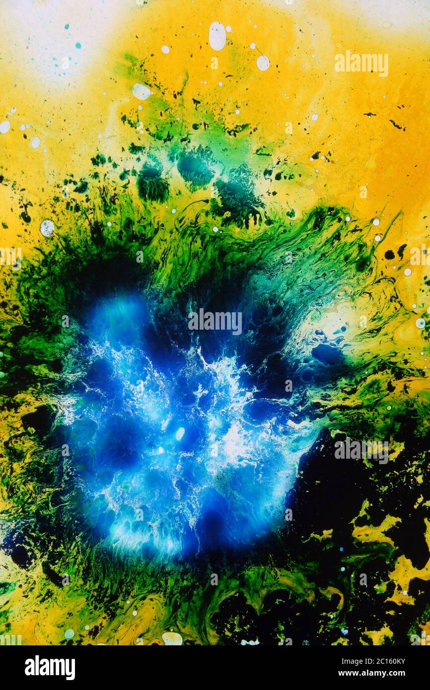 Colored liquids mixed together in fluid creating colorful abstract ...