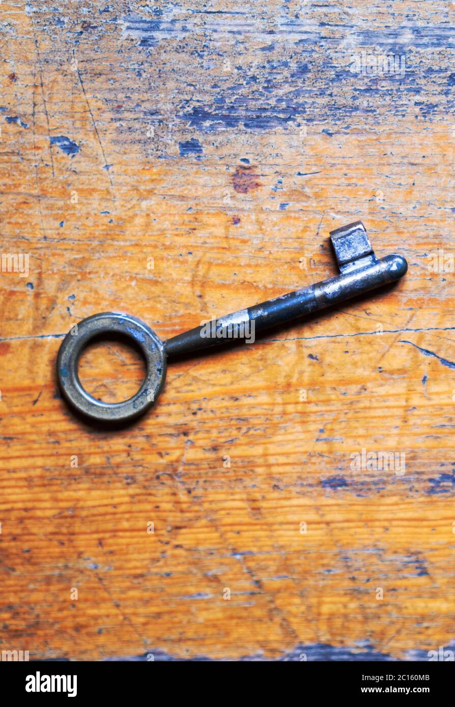 Old key on a worn out hardwood floor Stock Photo - Alamy