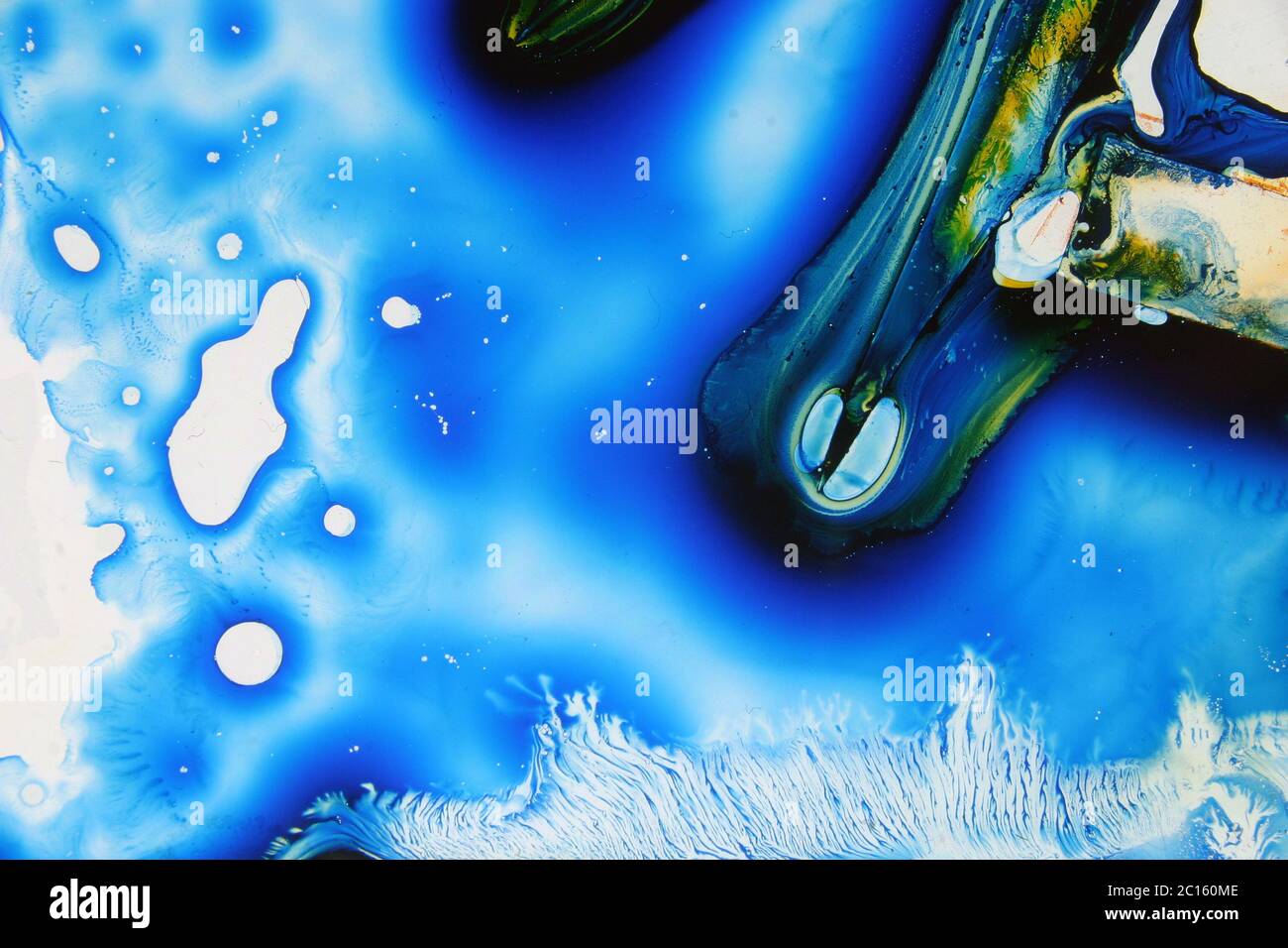 Colored liquids mixed together in fluid creating colorful abstract ...