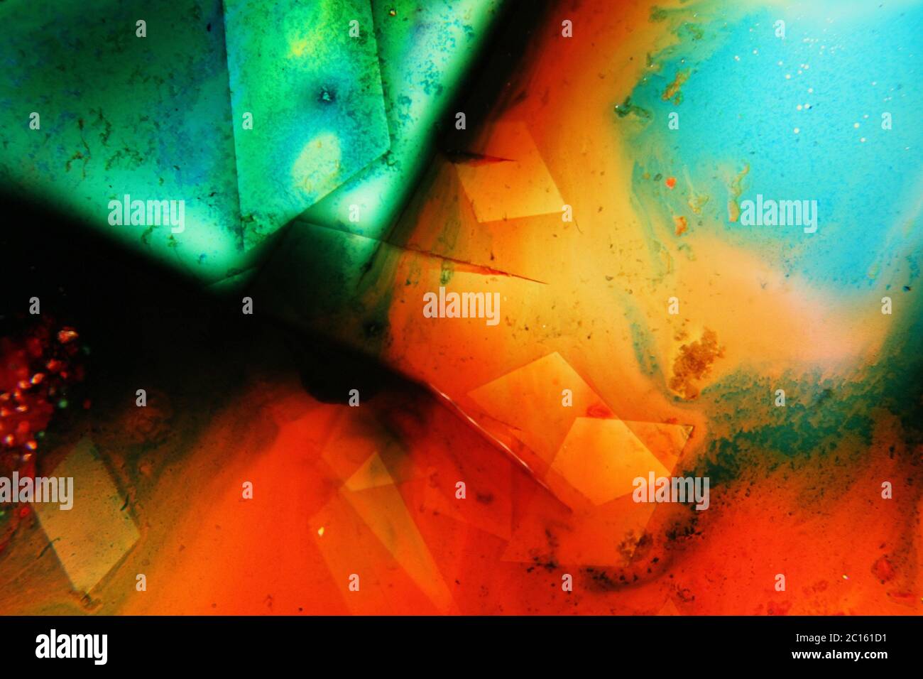 Colored liquids mixed together in fluid creating colorful abstract ...