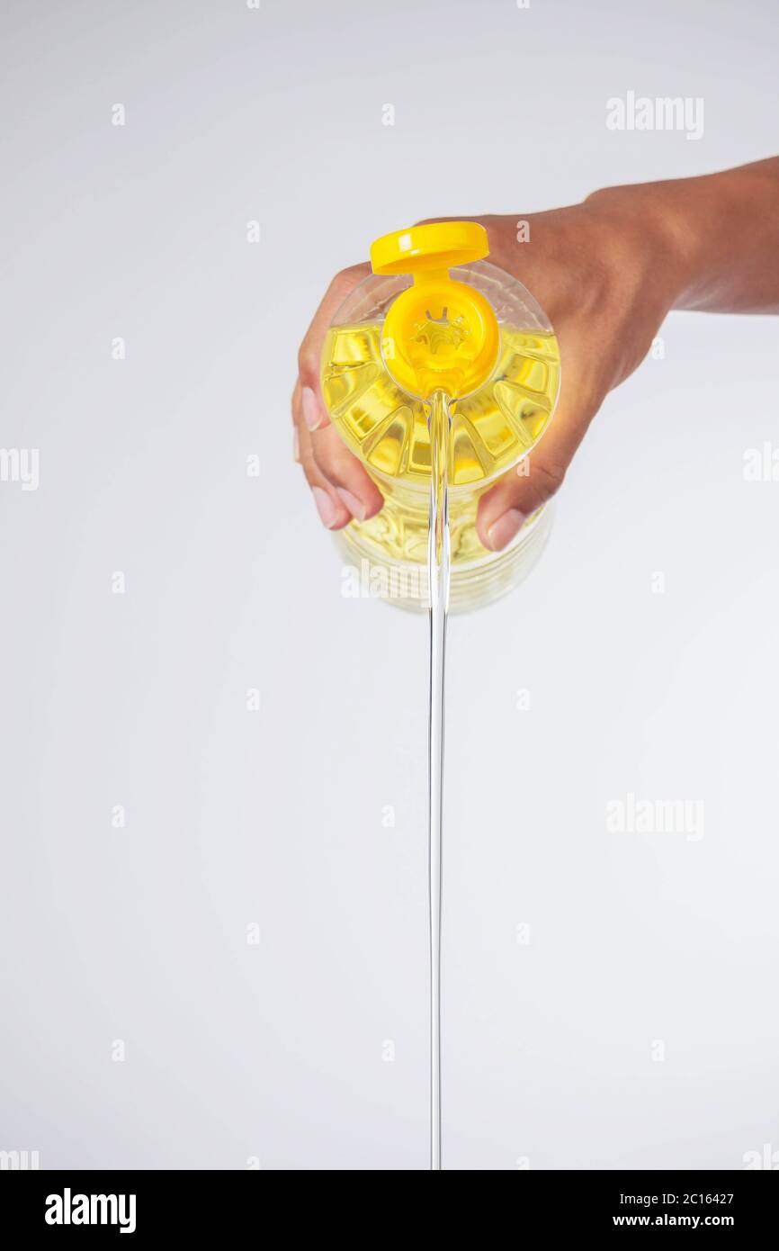 Hand is pouring oil Stock Photo - Alamy