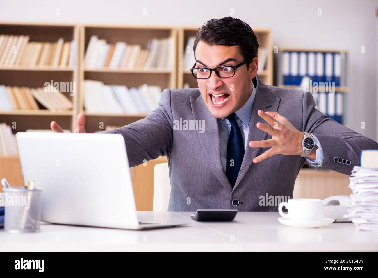 Angry businessman working in the office Stock Photo - Alamy
