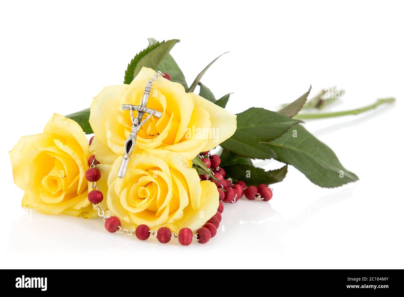 Silver crucifix and yellow roses Stock Photo - Alamy