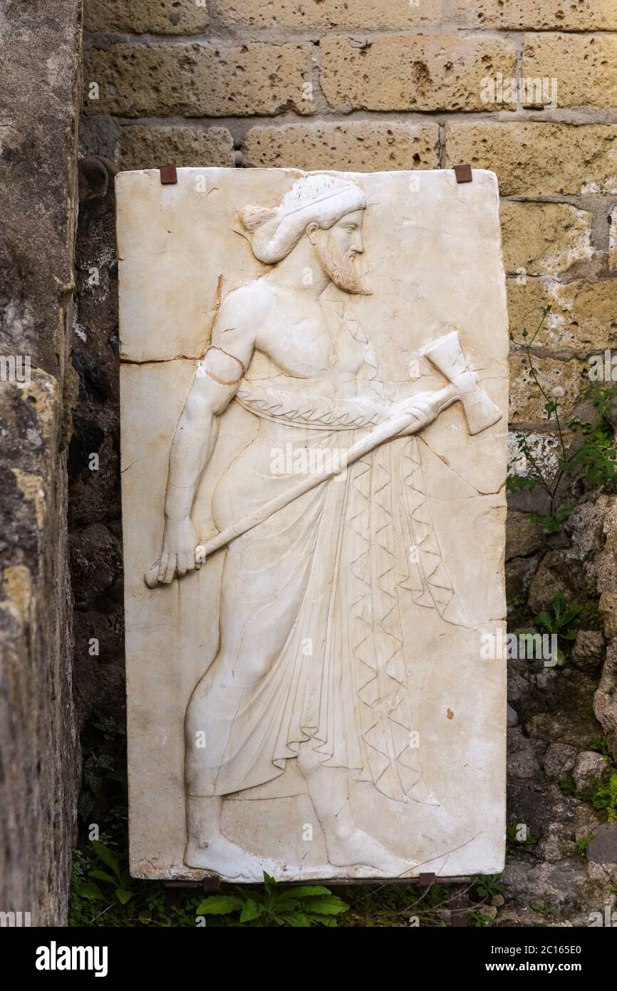 Replica relief carved tablet of the Roman god Vulcan in the sacred area ...