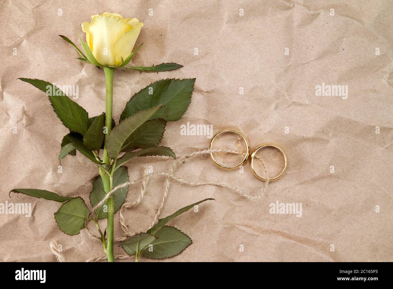 Roses and wedding rings tied with string Stock Photo - Alamy