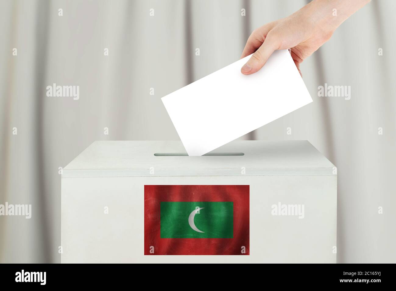 Maldives Vote concept. Voter hand holding ballot paper for election ...