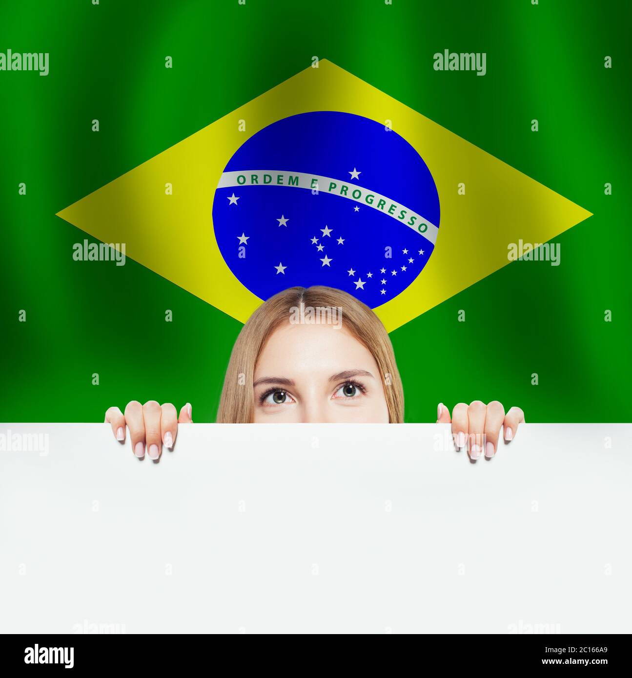 Happy cute girl with white banner against the Brazil flag background ...