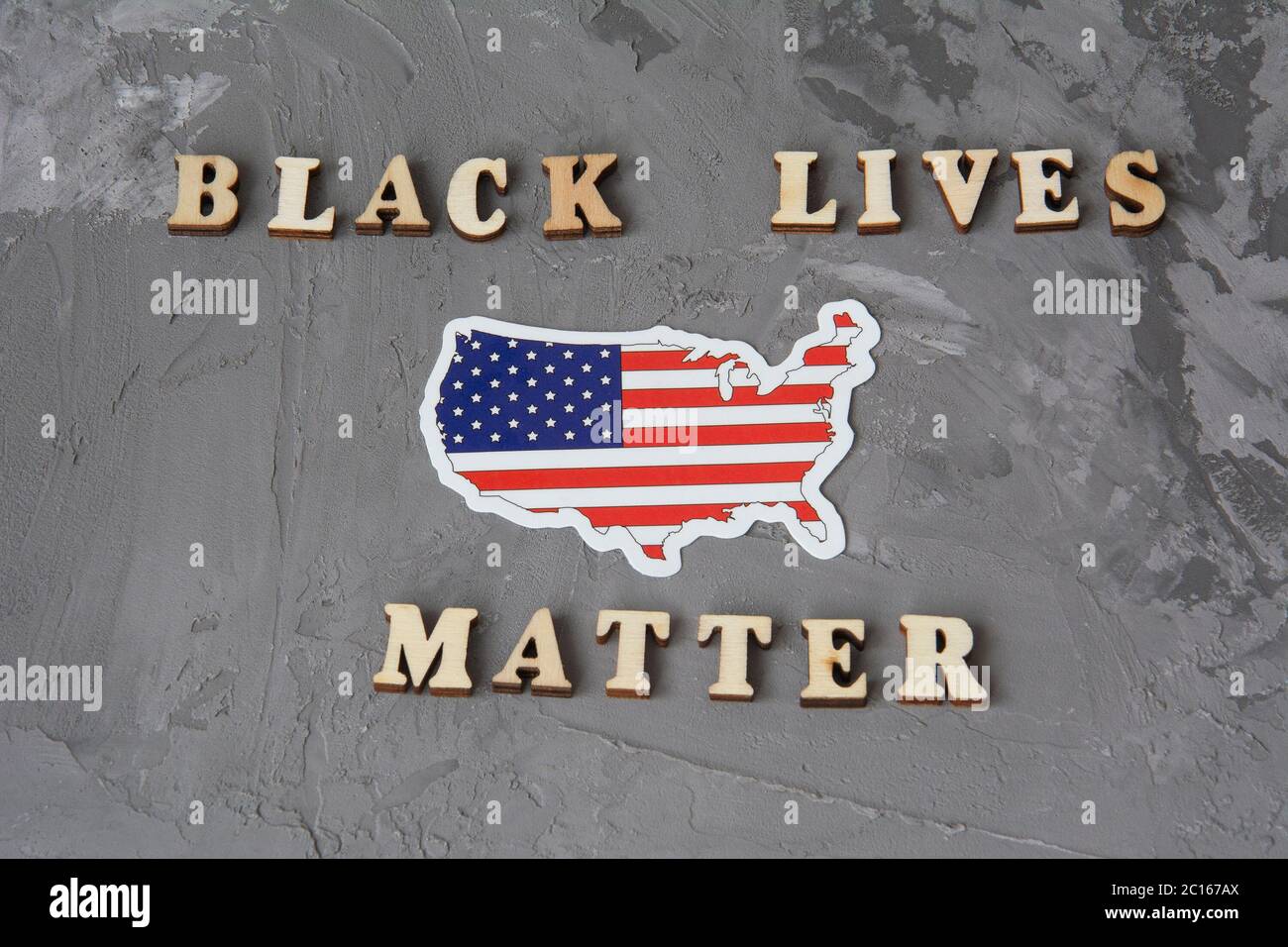 Black Lives Matter flat lay on a gray background with american flag ...