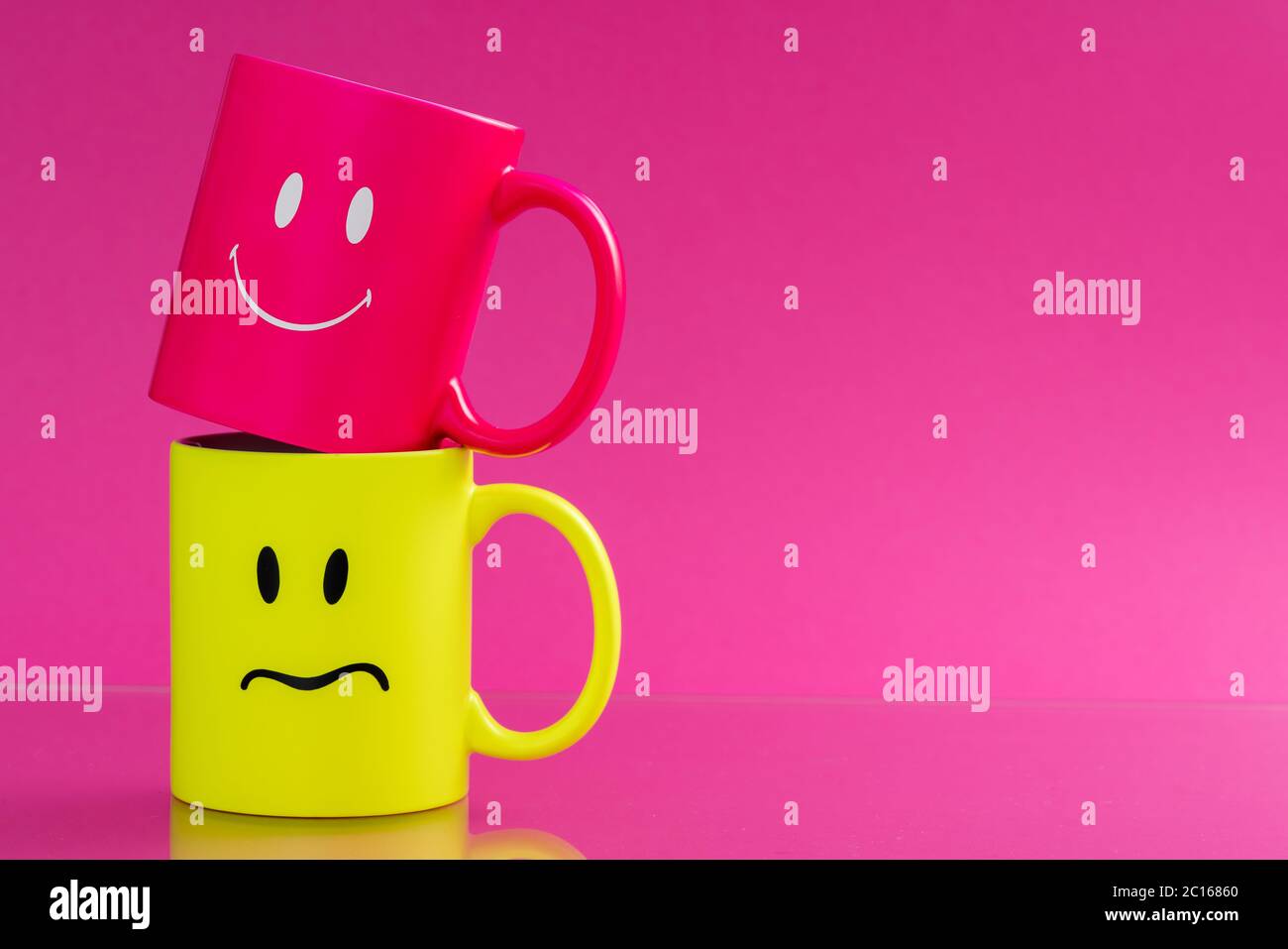 Two mugs with happy and sad emotions on the background. Concept, Coffee ...