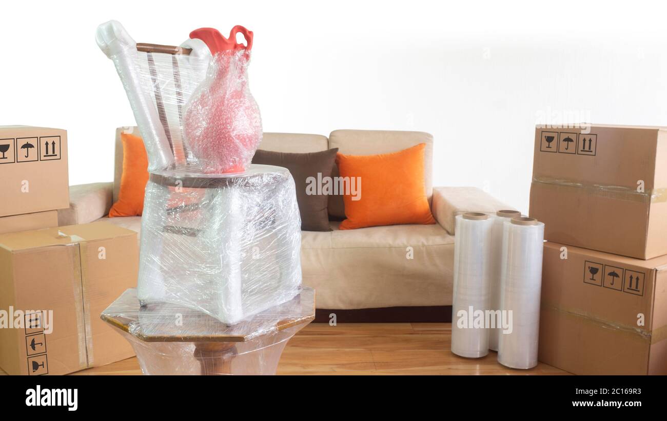 Moving scene with a vase on a chair on a table packed in plastic inside ...