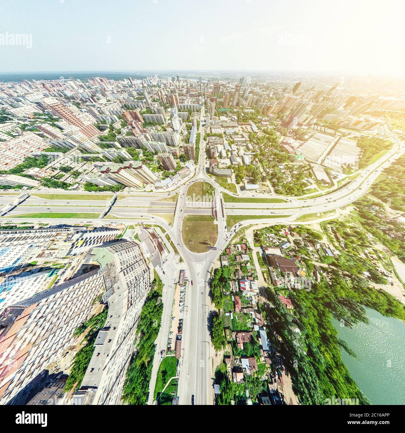 Aerial city view with crossroads and roads, houses, buildings, parks ...