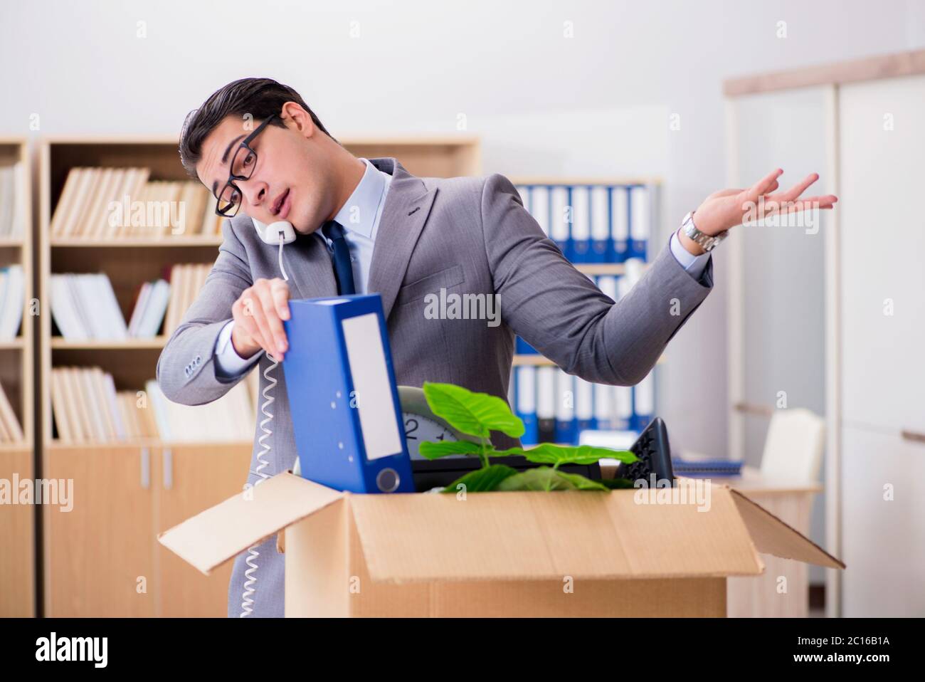 Man moving office with box and his belongings Stock Photo - Alamy