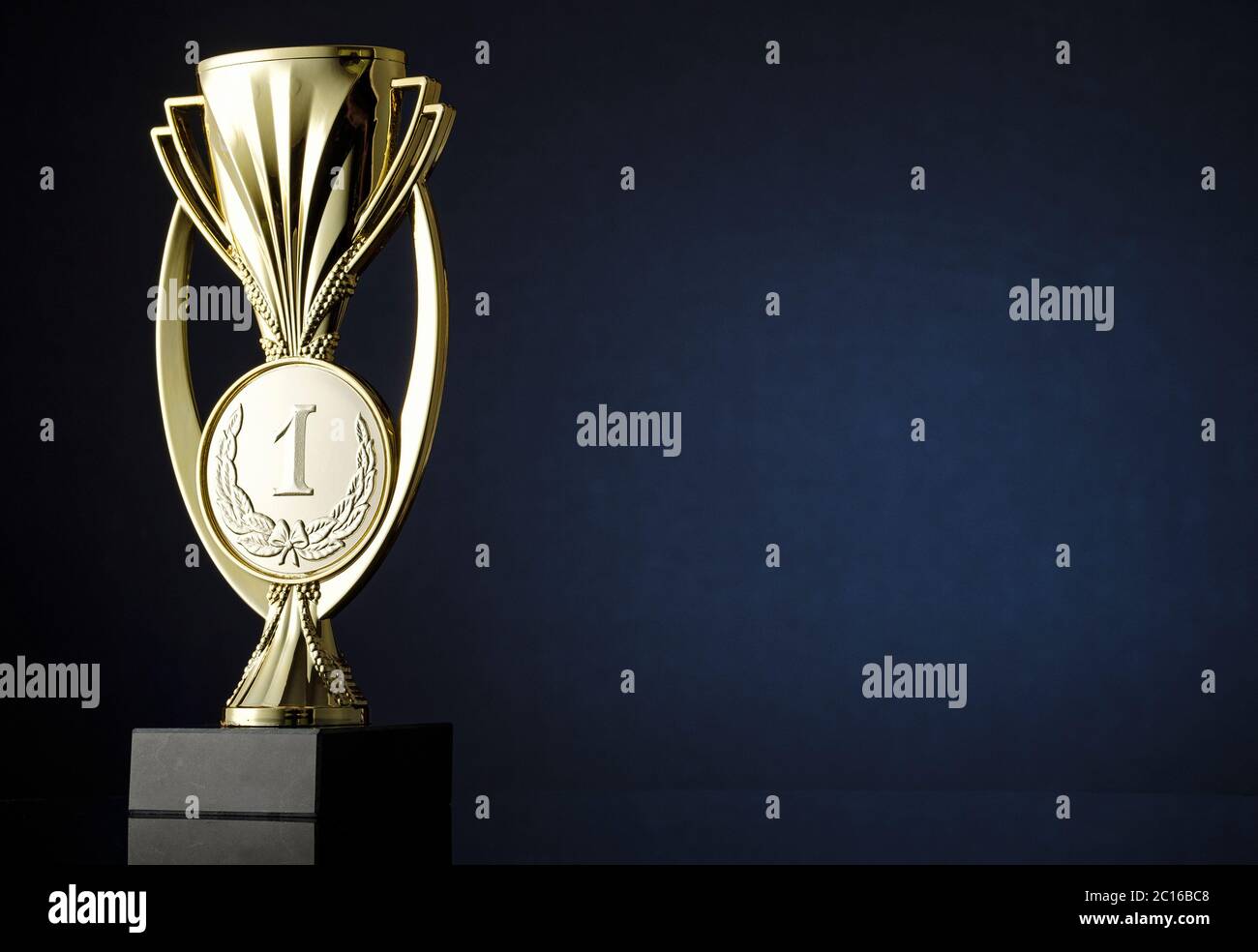 Gold cup or trophy with an engraved medallion with number 1 and laurel ...