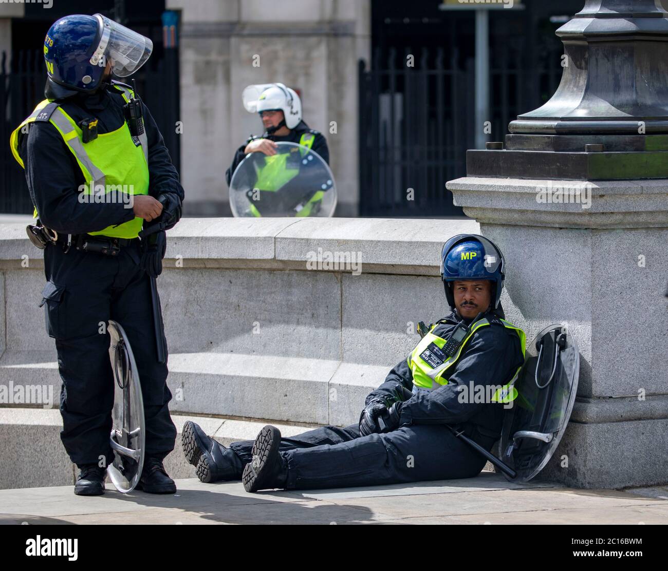 pic shows: Constable Black Exhausted riot cop takes a breather after ...