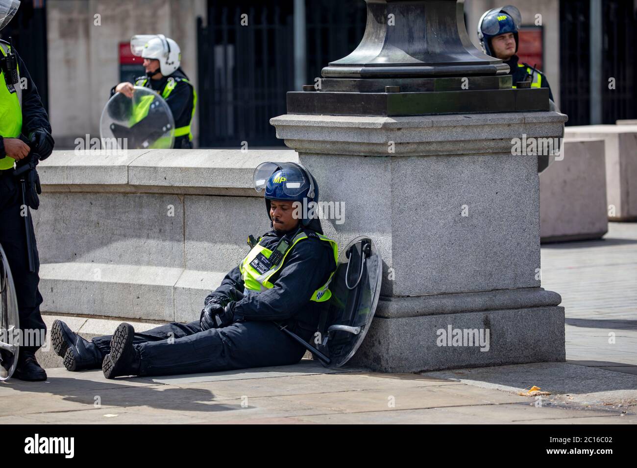 pic shows: Constable Black Exhausted riot cop takes a breather after ...