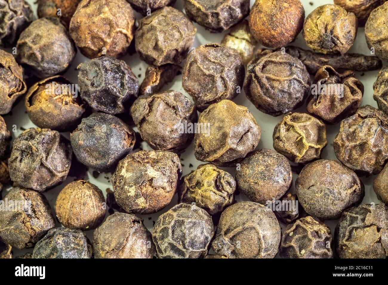 Black pepper corns close-up macro background, texture Stock Photo - Alamy