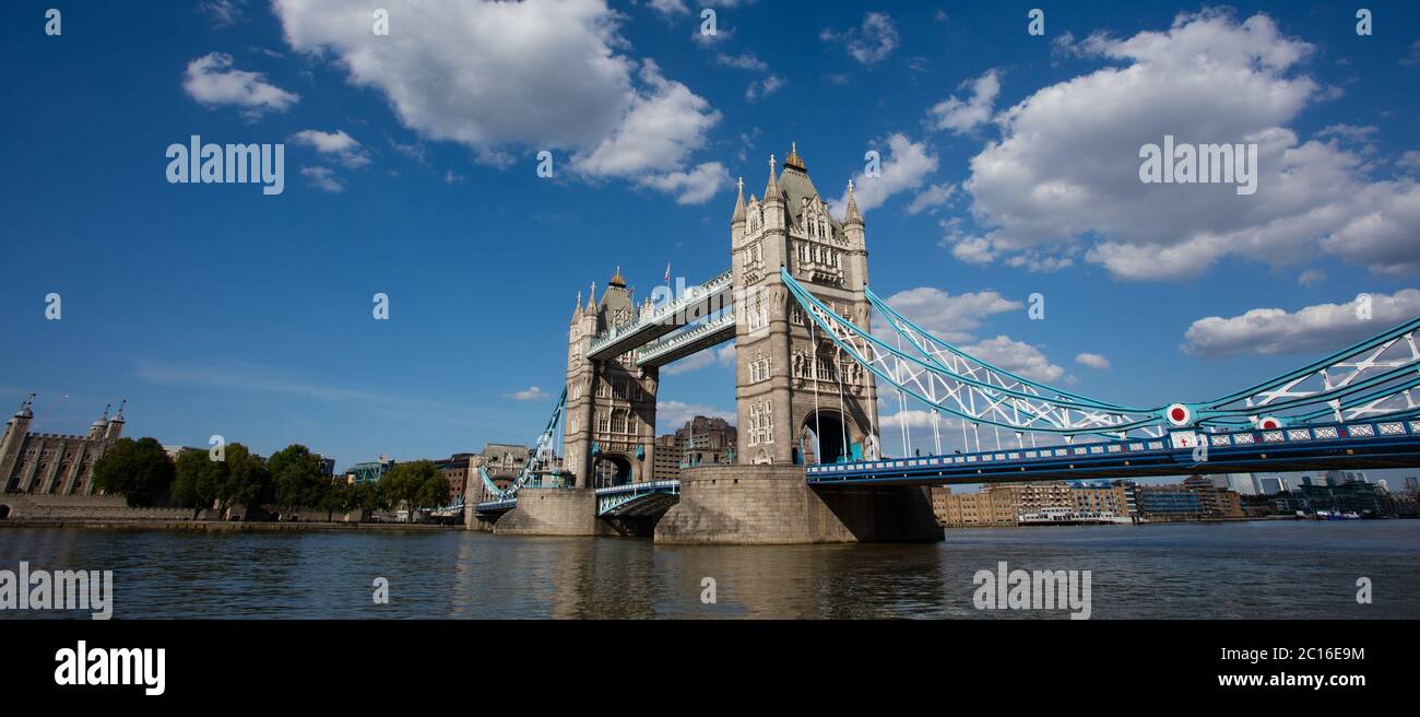 Tower Bridge against a bright blue sky with white clouds, London, UK ...