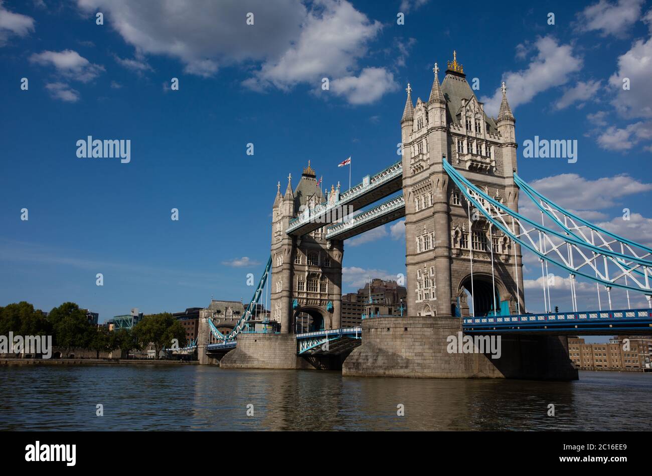 Tower Bridge against a bright blue sky with white clouds, London, UK ...