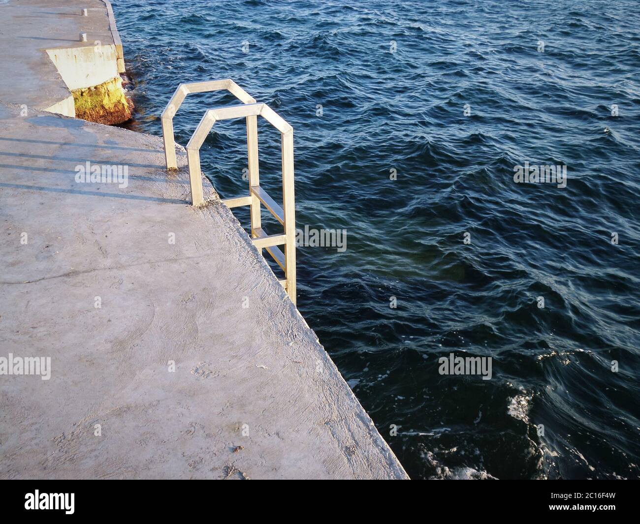 Ladder made of stainless steel into the water. Caspian Sea Stock Photo ...