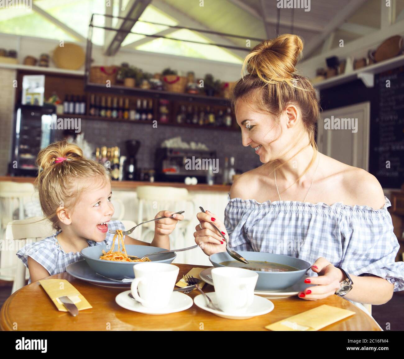 Mother and daughter in a restaurant Stock Photo - Alamy