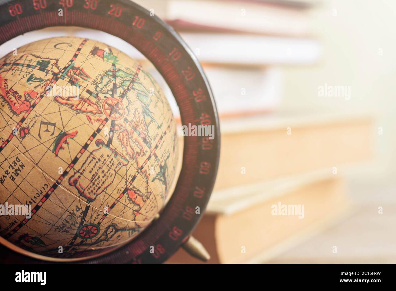 Globe in the library Stock Photo - Alamy