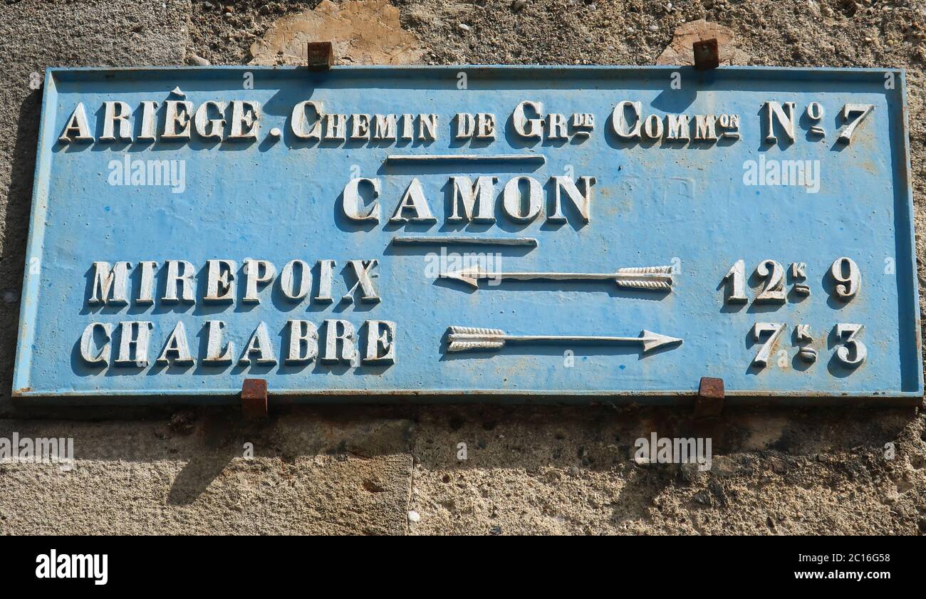 Old road distances sign on old building wall, Camon, Ariege, Occitanie ...