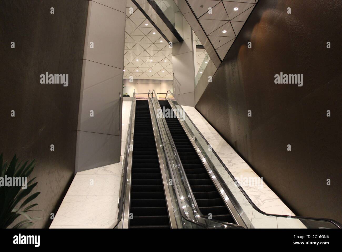 A pair of escalators in an office building on Queen's Road, Central ...